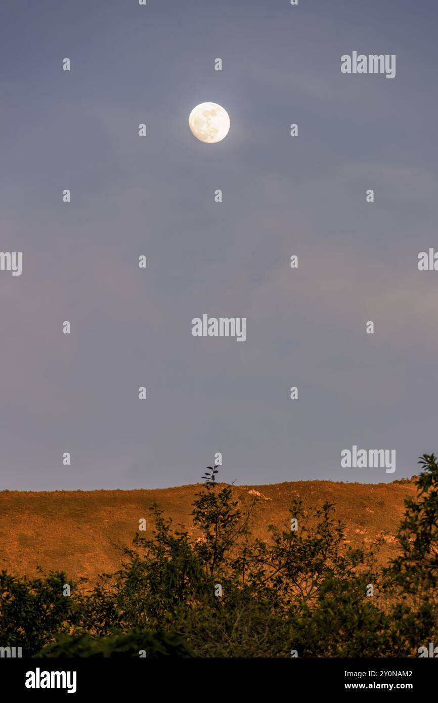 The almost full crescent moon rises over the Iguaque mountain, in the ...
