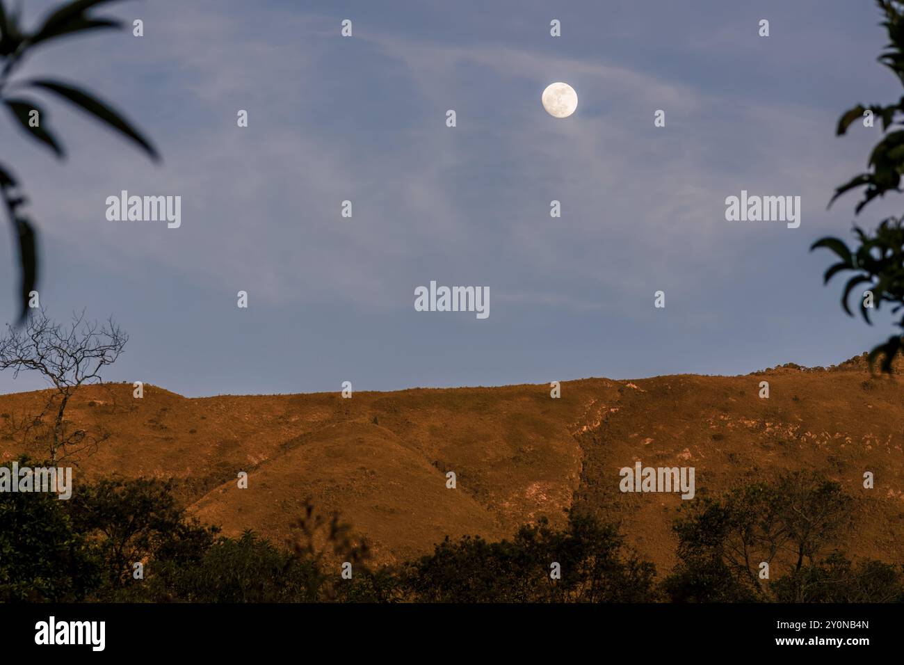 The almost full crescent moon rises over the Iguaque mountain, in the ...