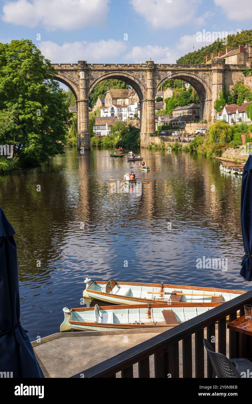 People in rowing boats near the viaduct on the River Nidd ...