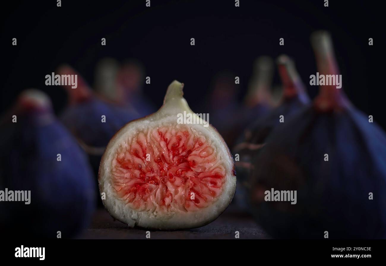 Freshly picked figs in rows with one out of line and cut in half Stock ...