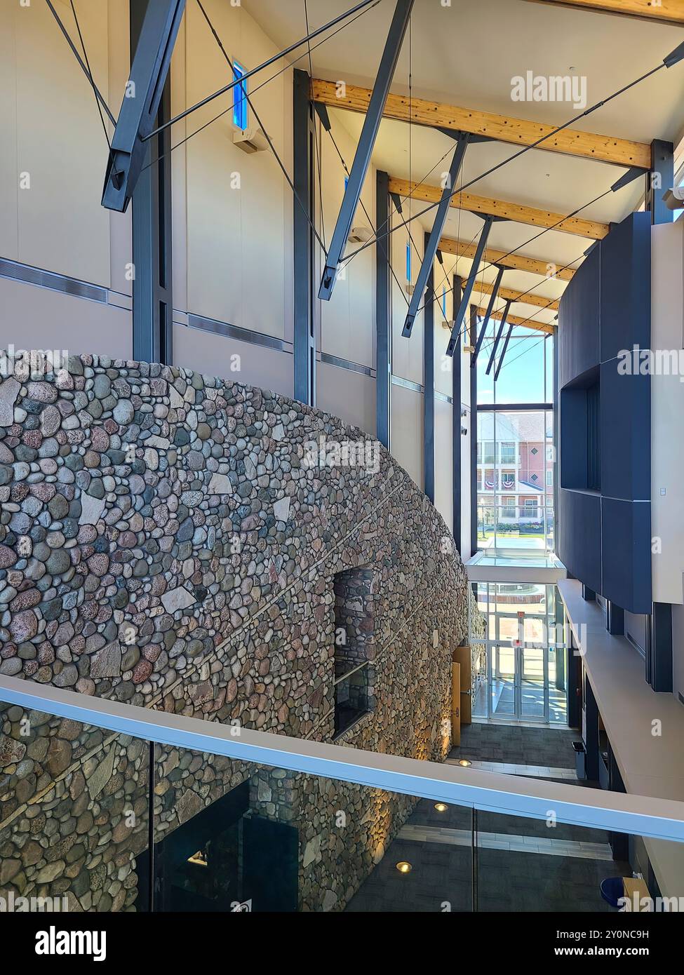 Curved Stone Wall and Exposed Beams in Modern Hallway Aerial ...