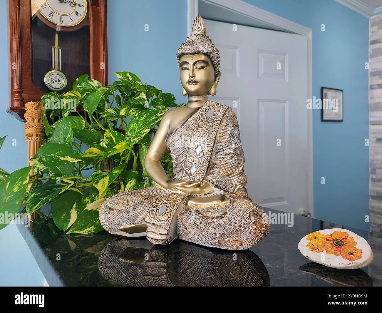 Buddha Statue with Pothos Plant and Pendulum Clock in Cozy Indoor ...