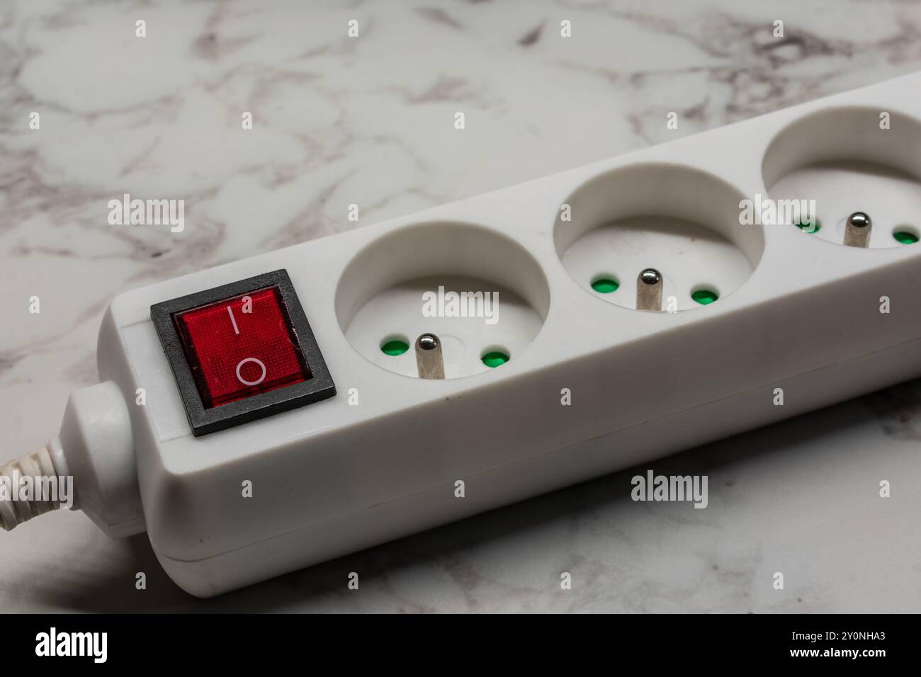 Power strip with a switch button, set against a white background, for easy control and ...
