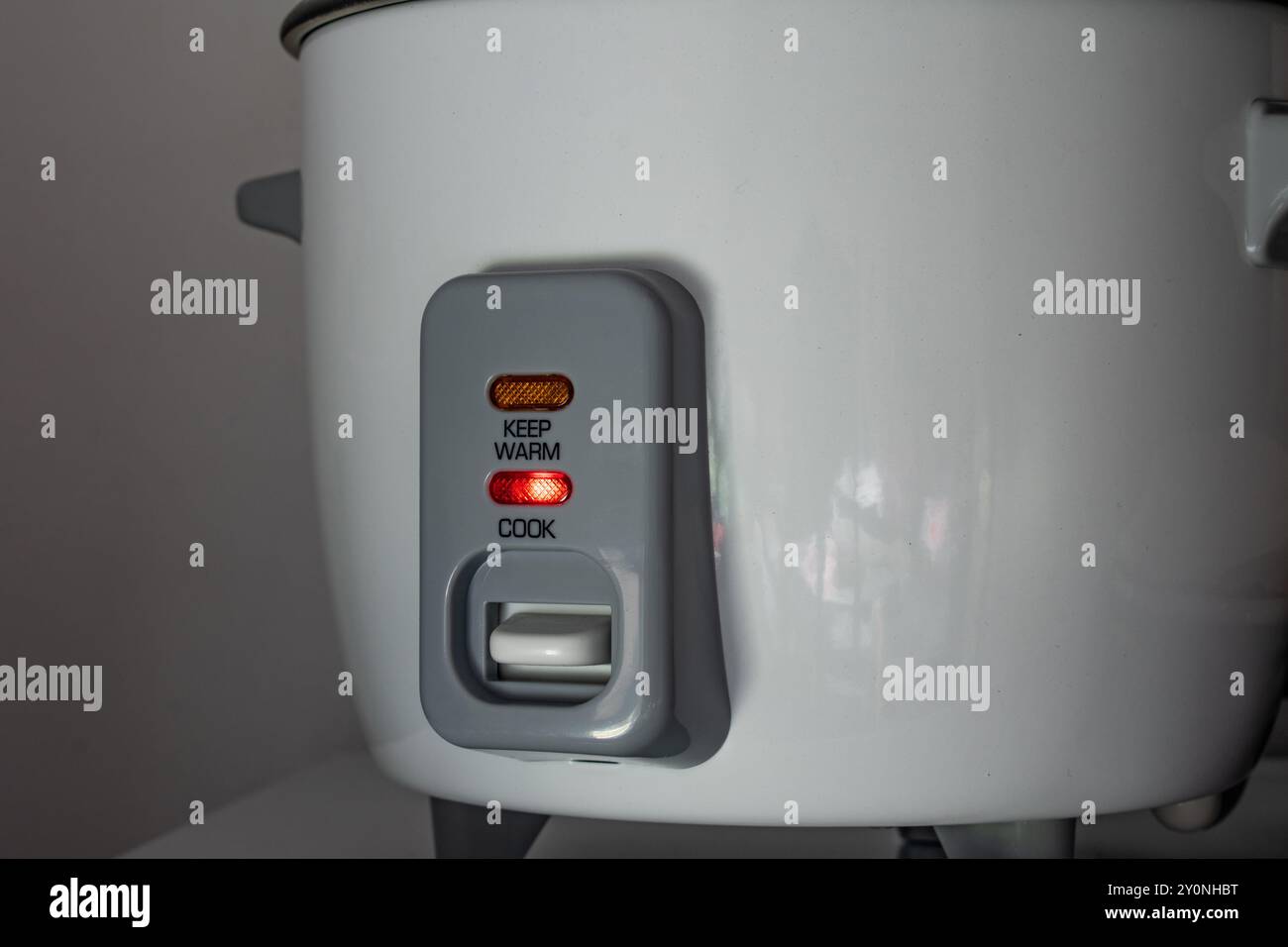 Sleek, minimalist rice cooker with a clear display indicating the ...