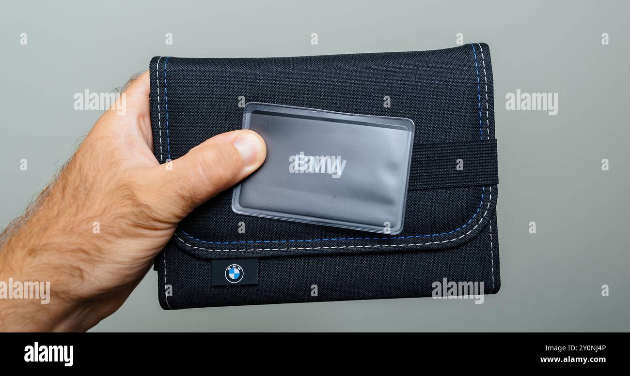 Munich, Germany - Sep 2, 2024: A male car owner's hand holds the BMW ...