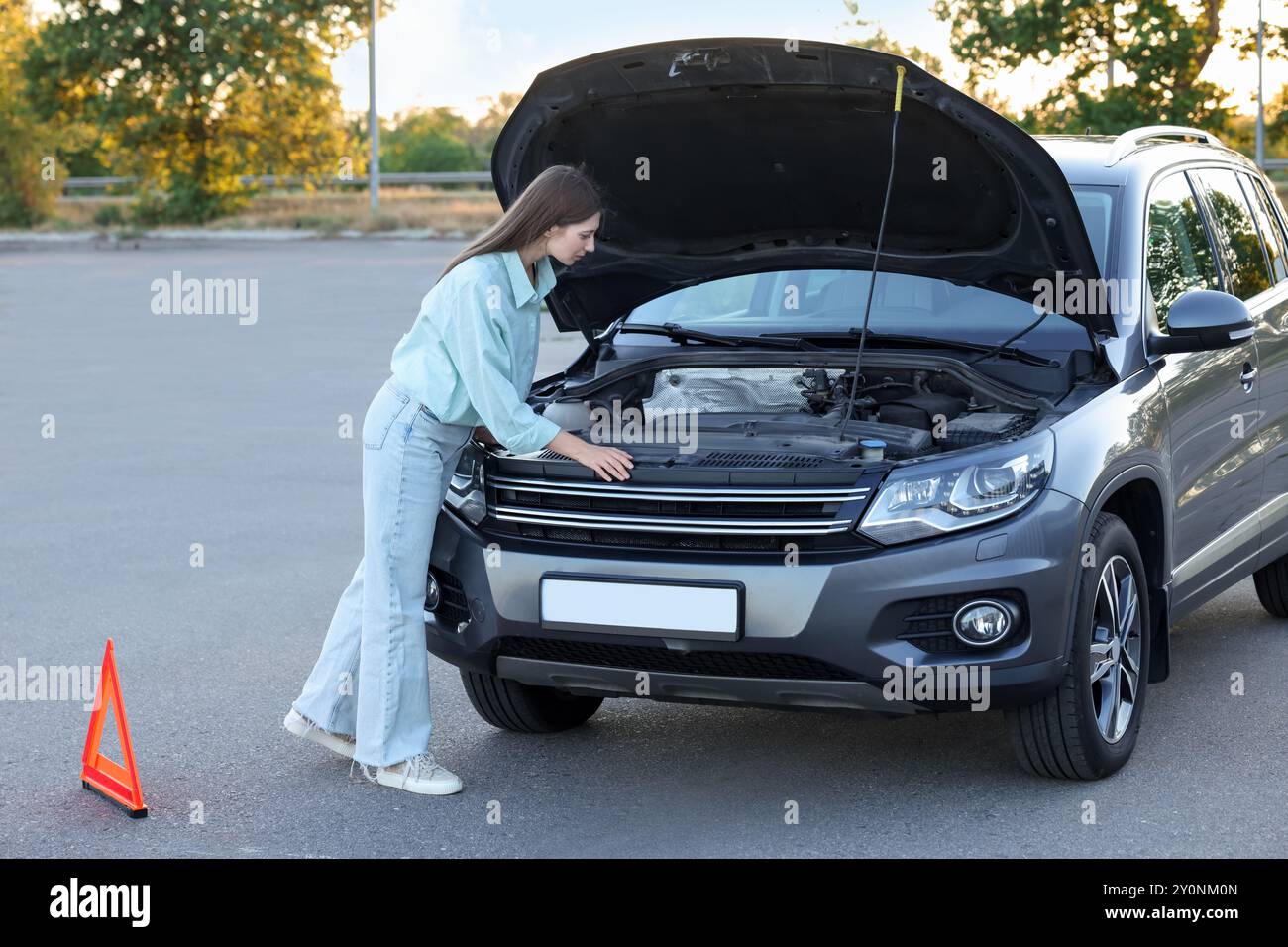 Female driver looking under hood hi-res stock photography and images ...