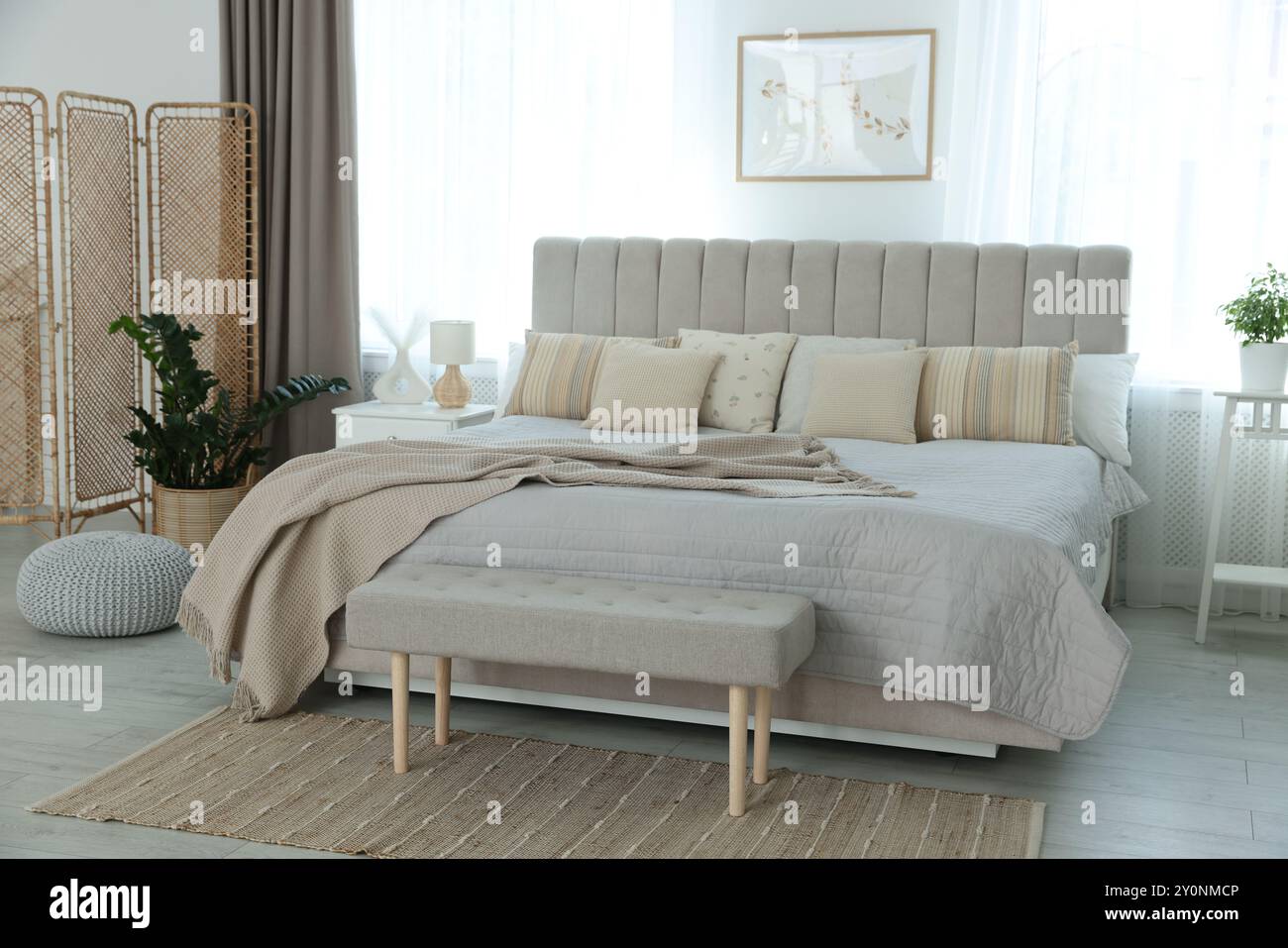 Big comfortable bed in room. Interior design Stock Photo - Alamy