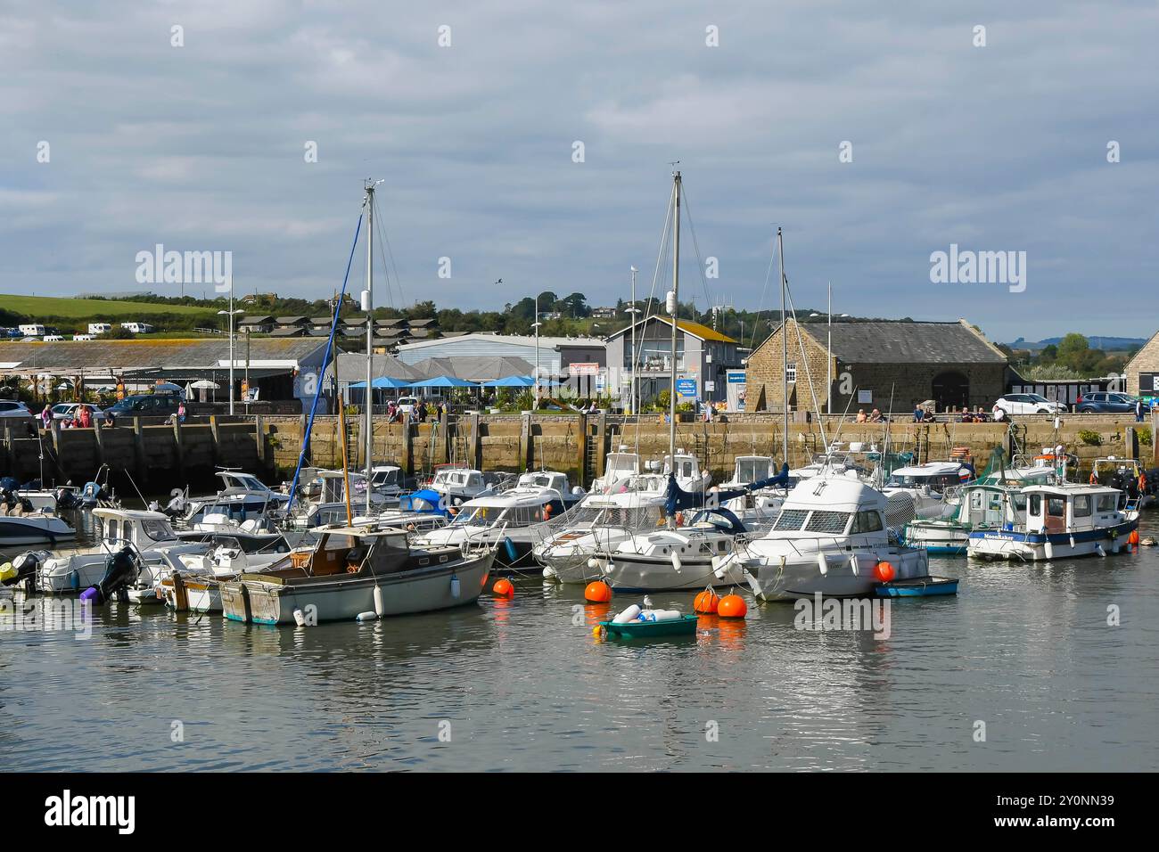 Boats in the harbour at the seaside resort of West Bay in Dorset on an ...