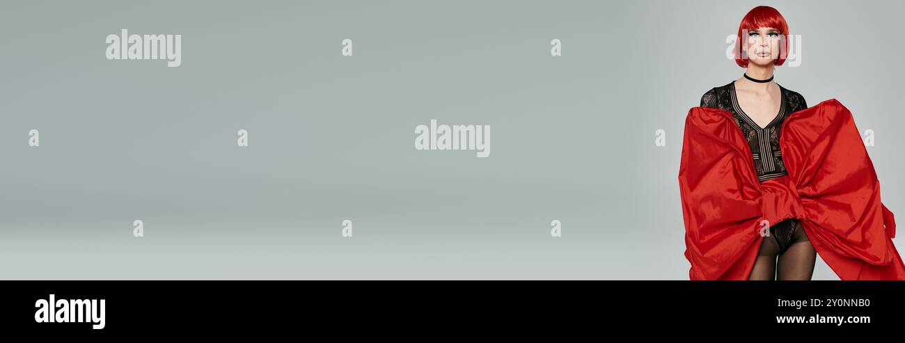 An attractive young drag queen showcases a striking outfit in a ...