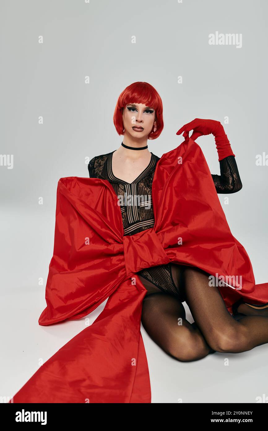 A glamorous drag queen showcases stunning style in a bold red outfit ...