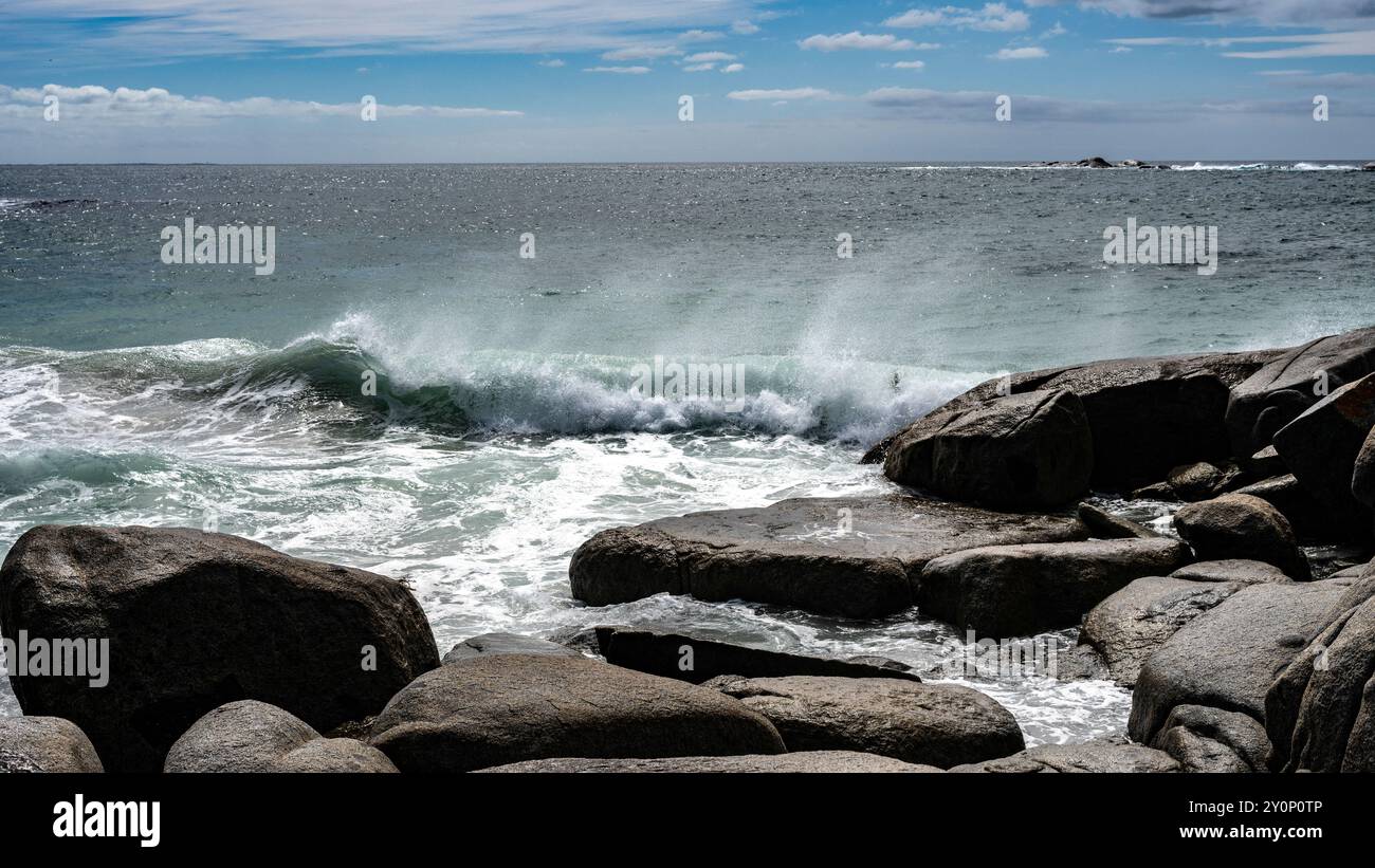 Ocean waves crashing against the Bay of Fires which was given its name ...