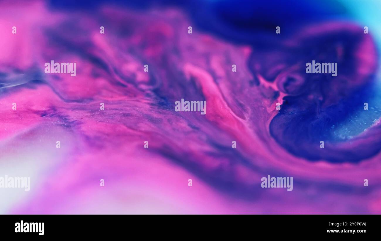 Glitter fluid mix. Paint spill. Defocused pink blue color shimmering ...