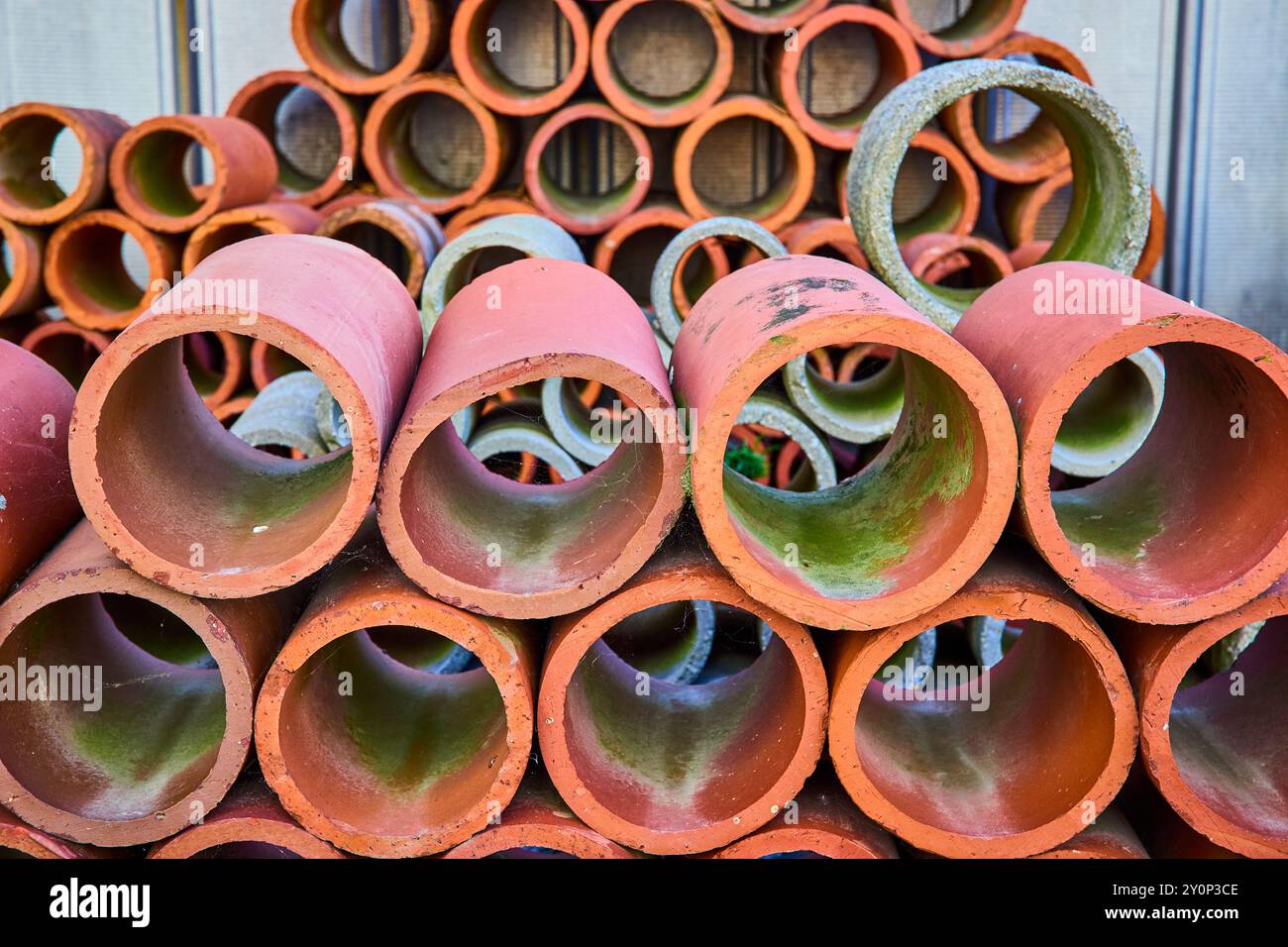 Stacked Terracotta Pipes in Triangle Formation at Eye Level Stock Photo ...