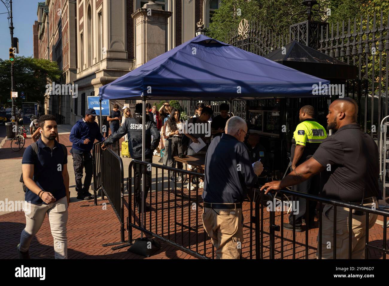 People wait in line to walk through a security check outside Columbia ...