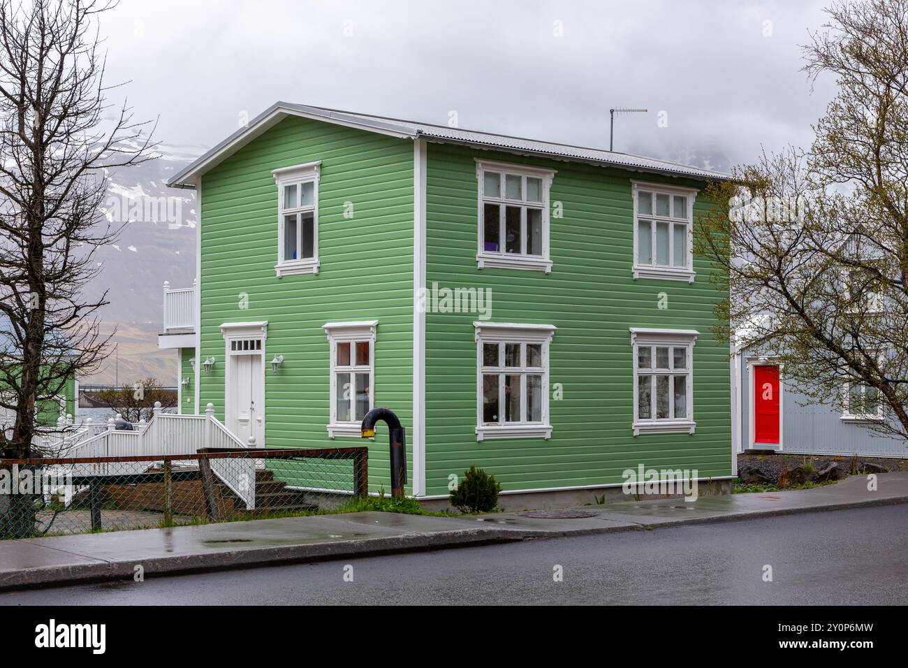 Traditional Icelandic green residential house, white window frames ...