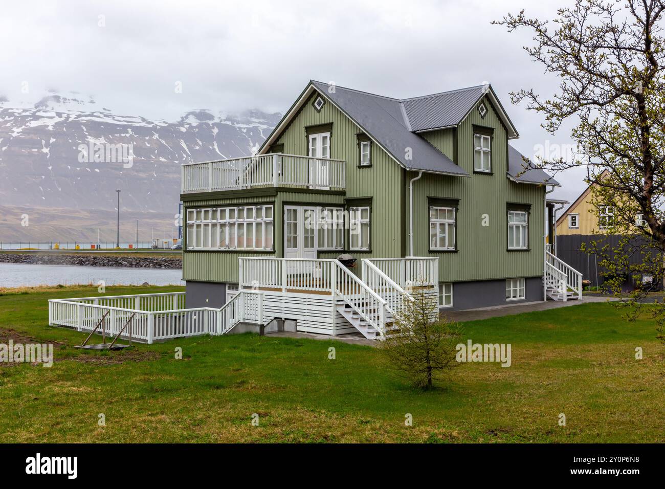 Traditional Icelandic green residential house with gable roof, white ...
