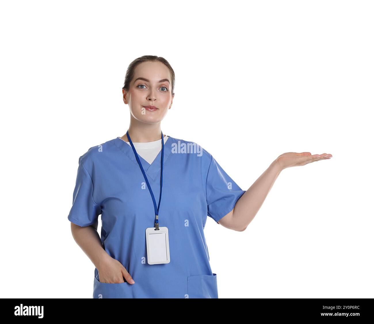Professional nurse with badge pointing at something on white background ...