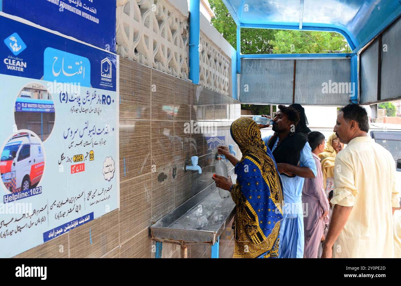 People are drinking water and filling their water bottles from filter ...