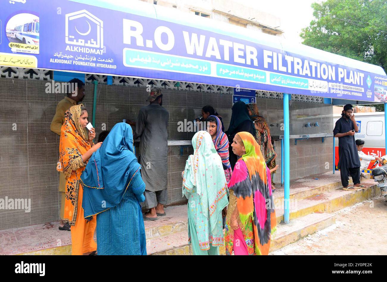 People are drinking water and filling their water bottles from filter ...