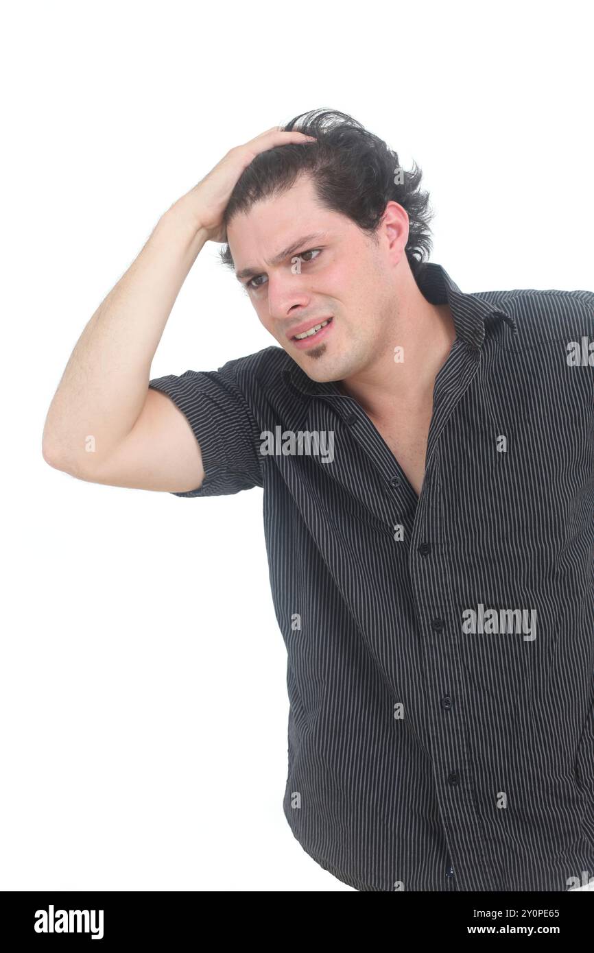 worried and stressed out young man looking panicky on isolated white ...