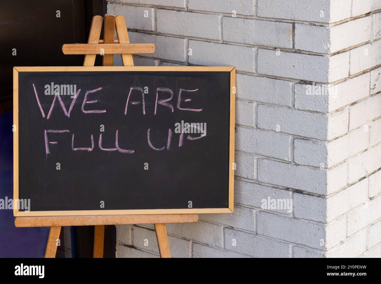 We Are Full Up sign on blackboard white brick background Stock Photo ...