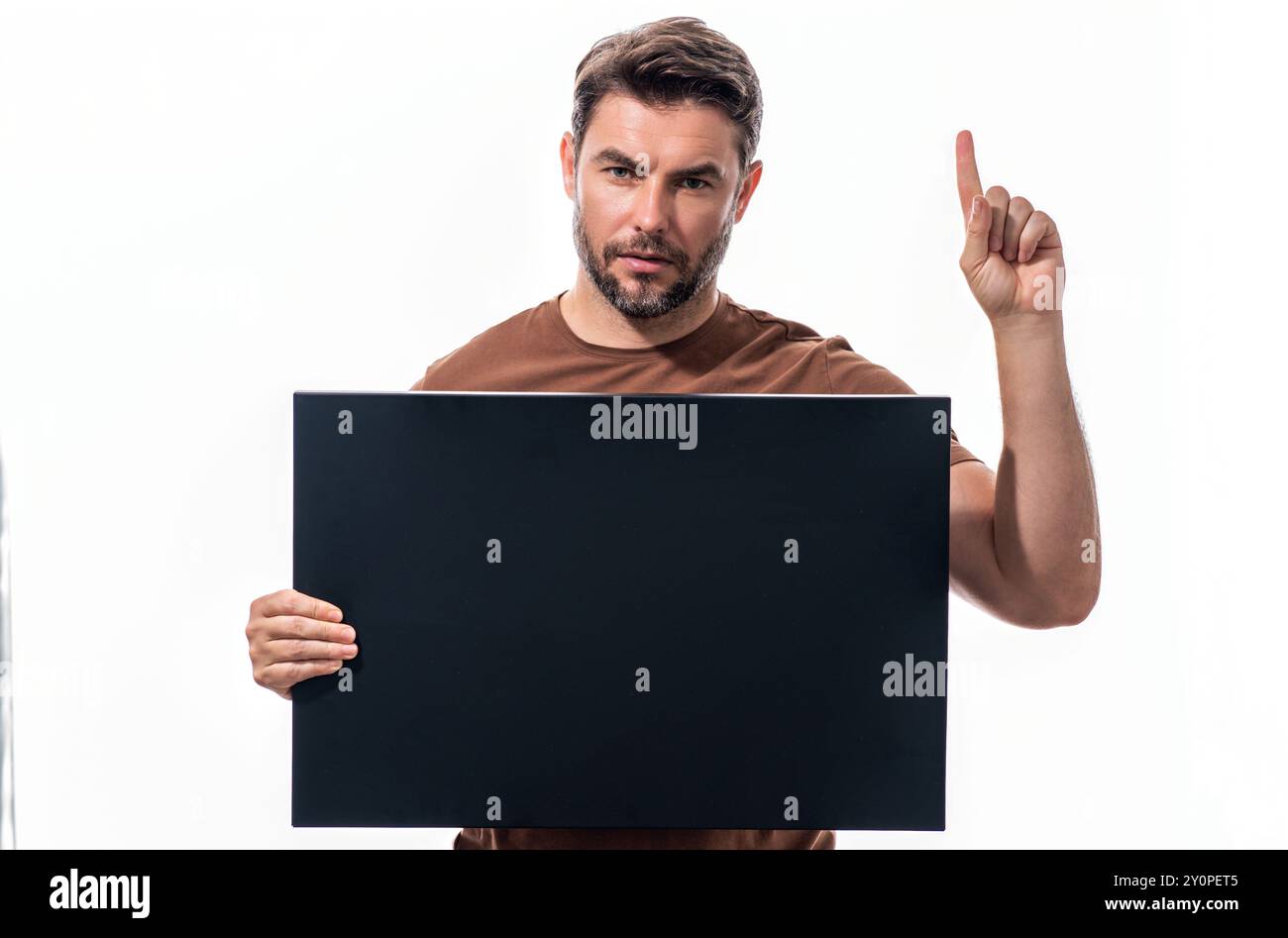 Happy man hold board thinking of idea on studio background. Portrait of ...