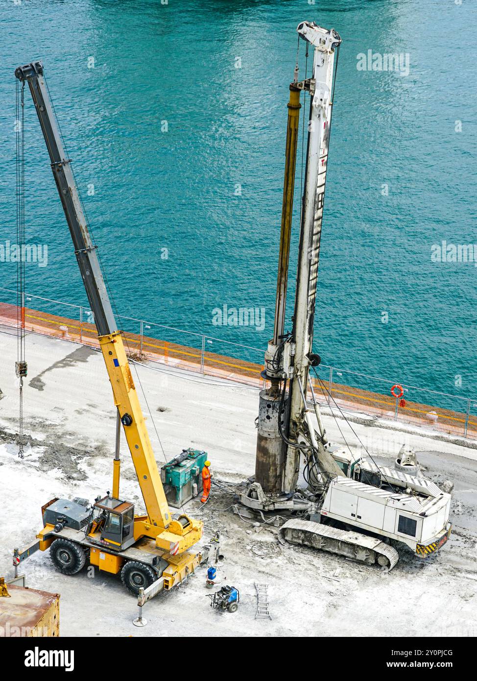 Installation of pile casings in the port quay, drilling rig machine ...