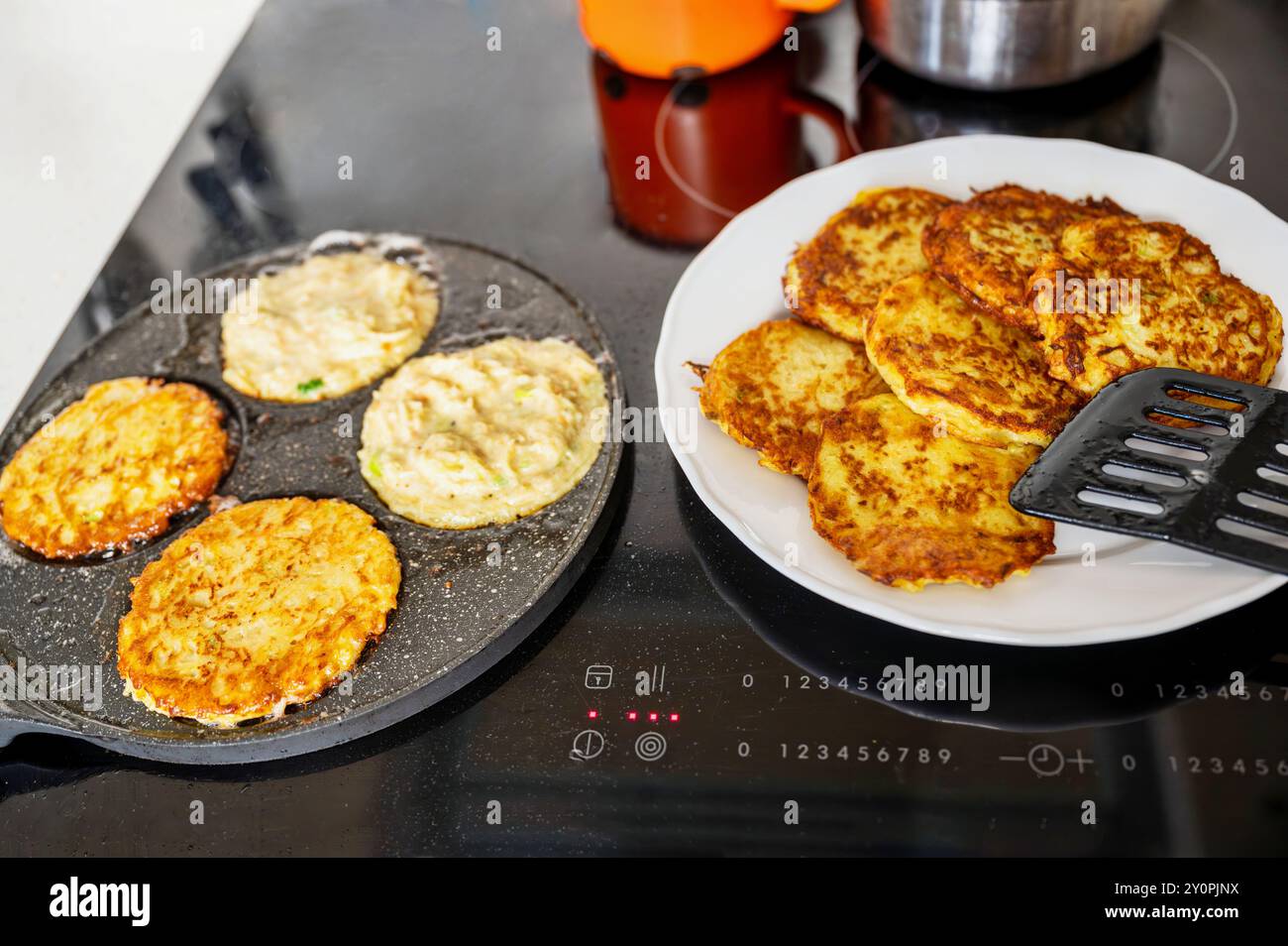 Preparation meal, frying small salty potato pancakes on hob. Ready ...