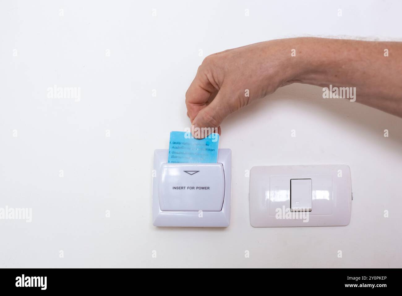 A man uses an electronic key card in a hotel room. Contactless card for ...