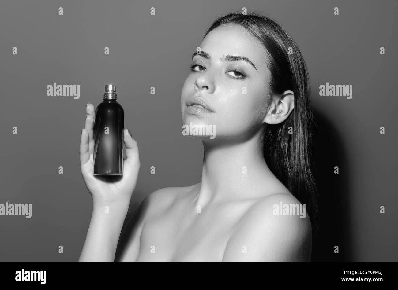 Perfume bottle. Woman with spray aroma perfume. Woman holding a ...