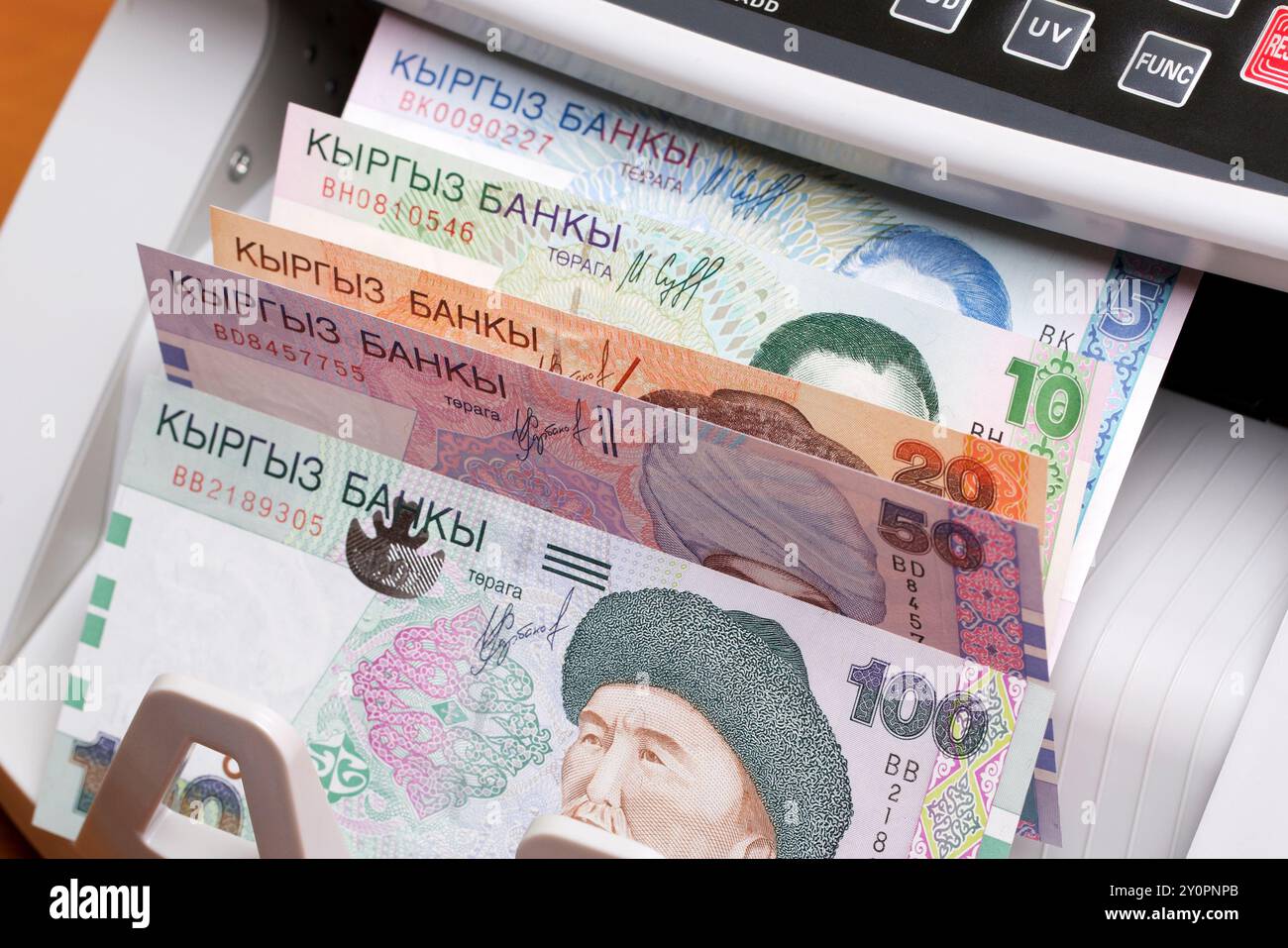 Old Kyrgyz money - som in the counting machine Stock Photo - Alamy