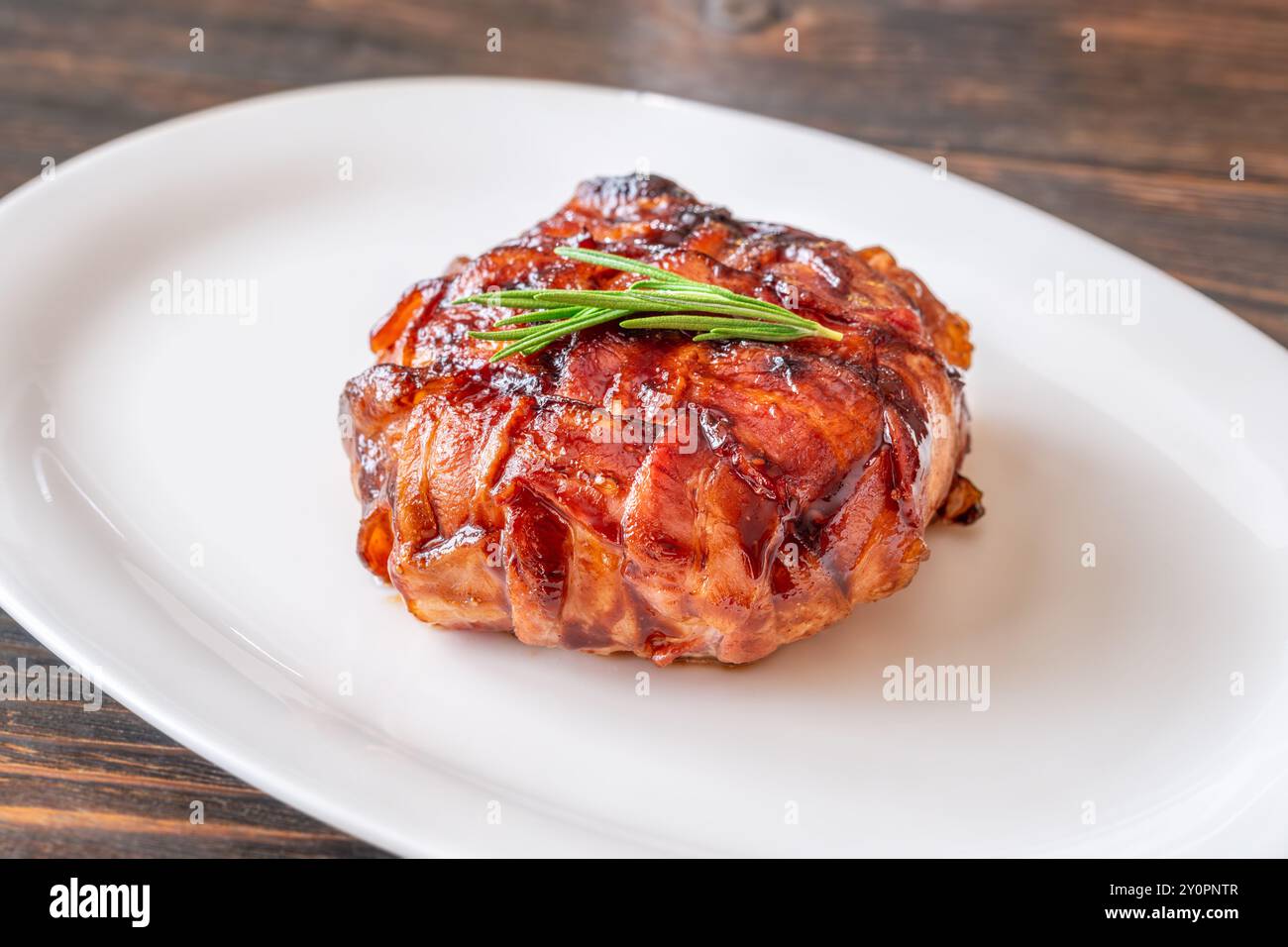 Camembert cheese wheel wrapped in glazed bacon Stock Photo - Alamy