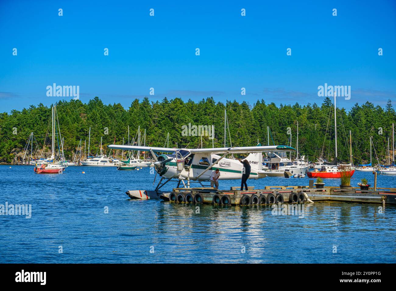 A seaplane being tied up at a dock in the Gulf Islands of British ...