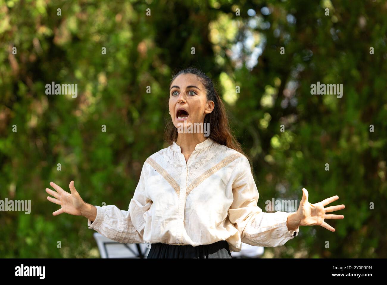 Brunette actress wearing a period costume is reciting a monologue ...