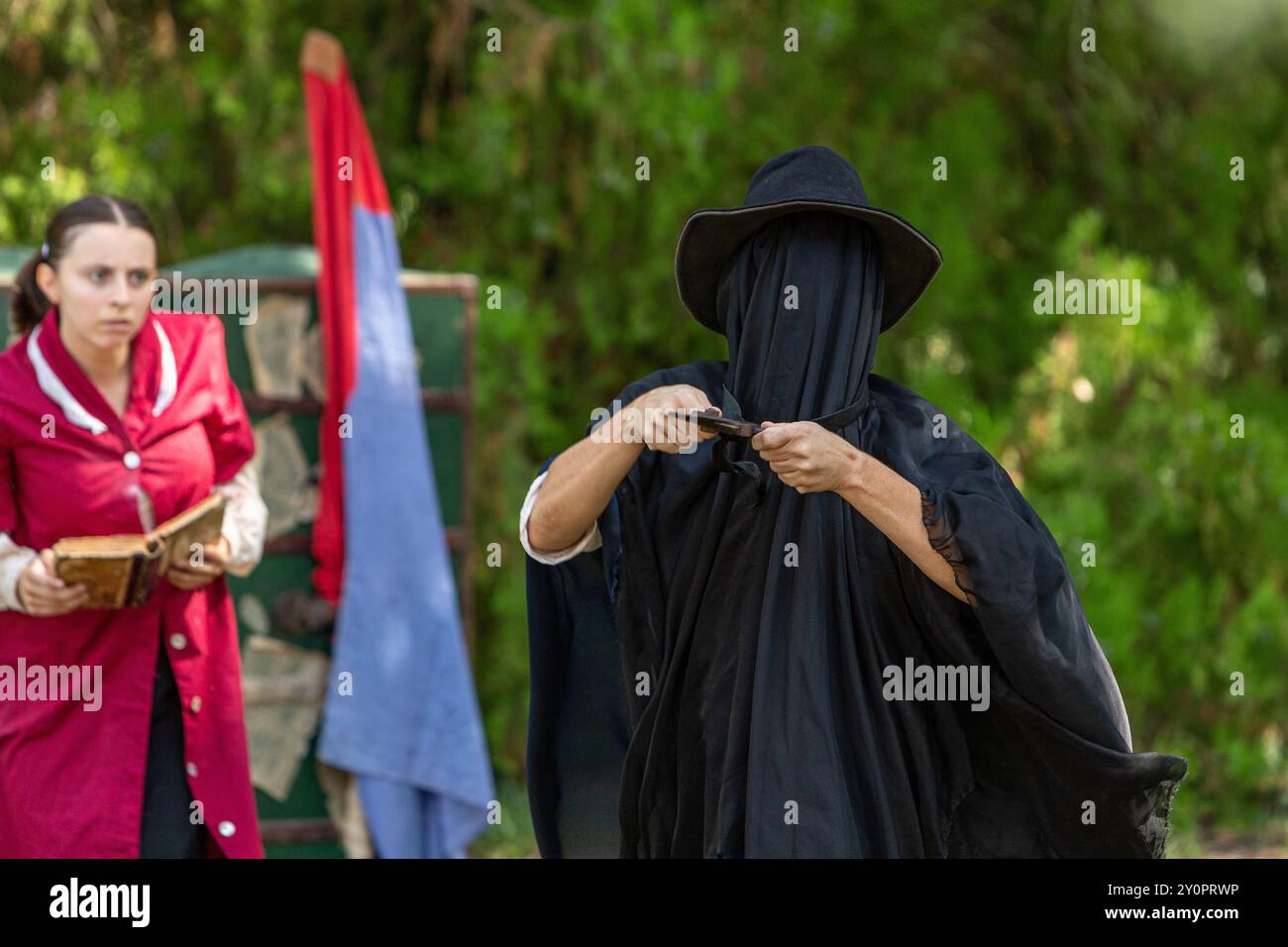 Executioner wearing black sharpening knife getting ready to behead ...