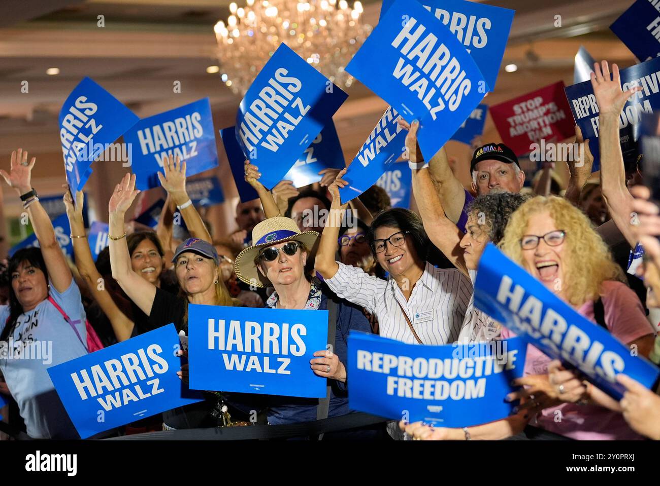 Attendees cheer as speakers arrive at an event kicking off a national ...