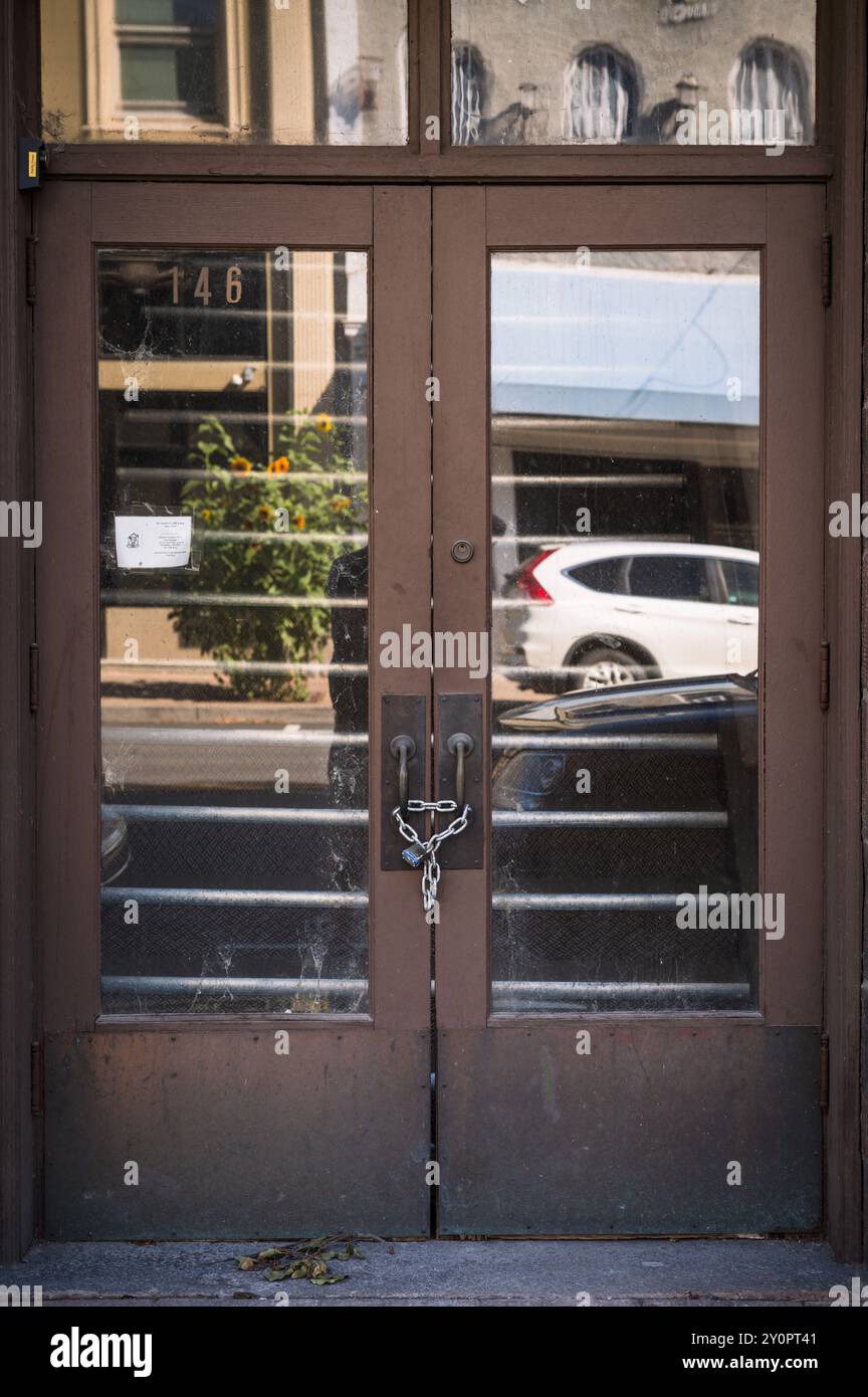 A chained and padlocked building door on a small town main street Stock ...