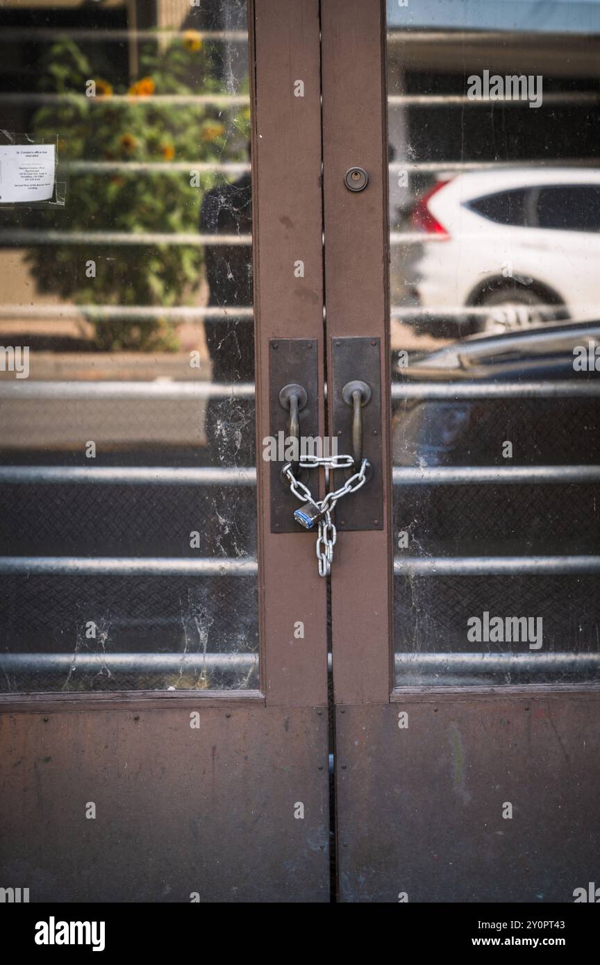 A chained and padlocked building door on a small town main street Stock ...