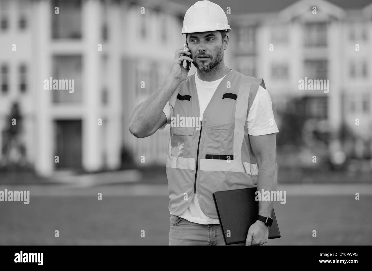 Builder using phone. Construction man in helmet build new house ...