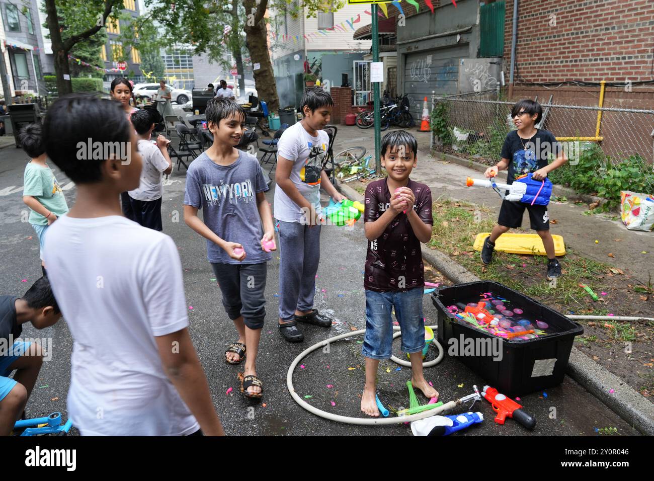 Kids make water balloons and have fun having water fights on a hot ...
