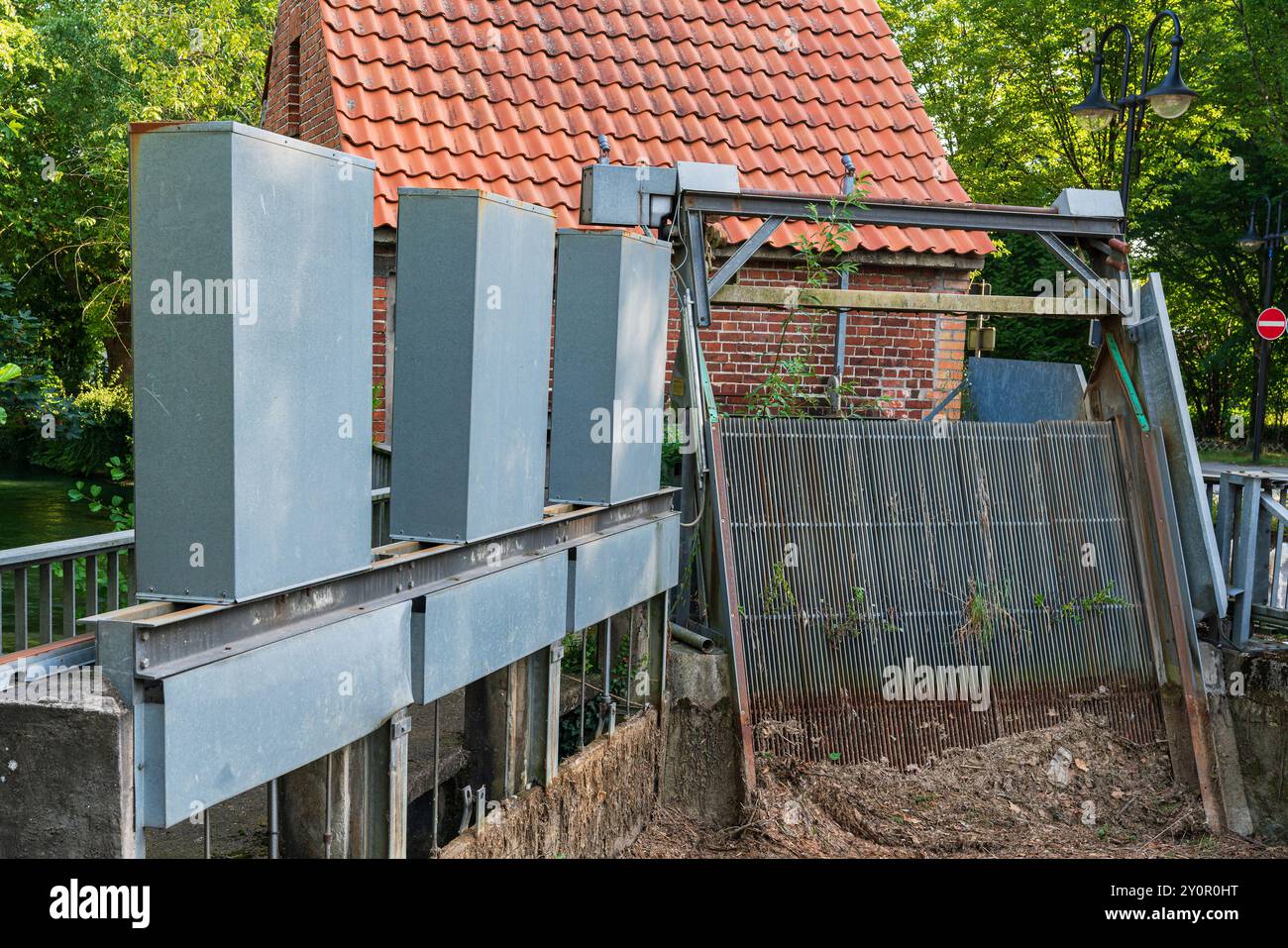 A water control structure featuring several metal gates stands near a ...