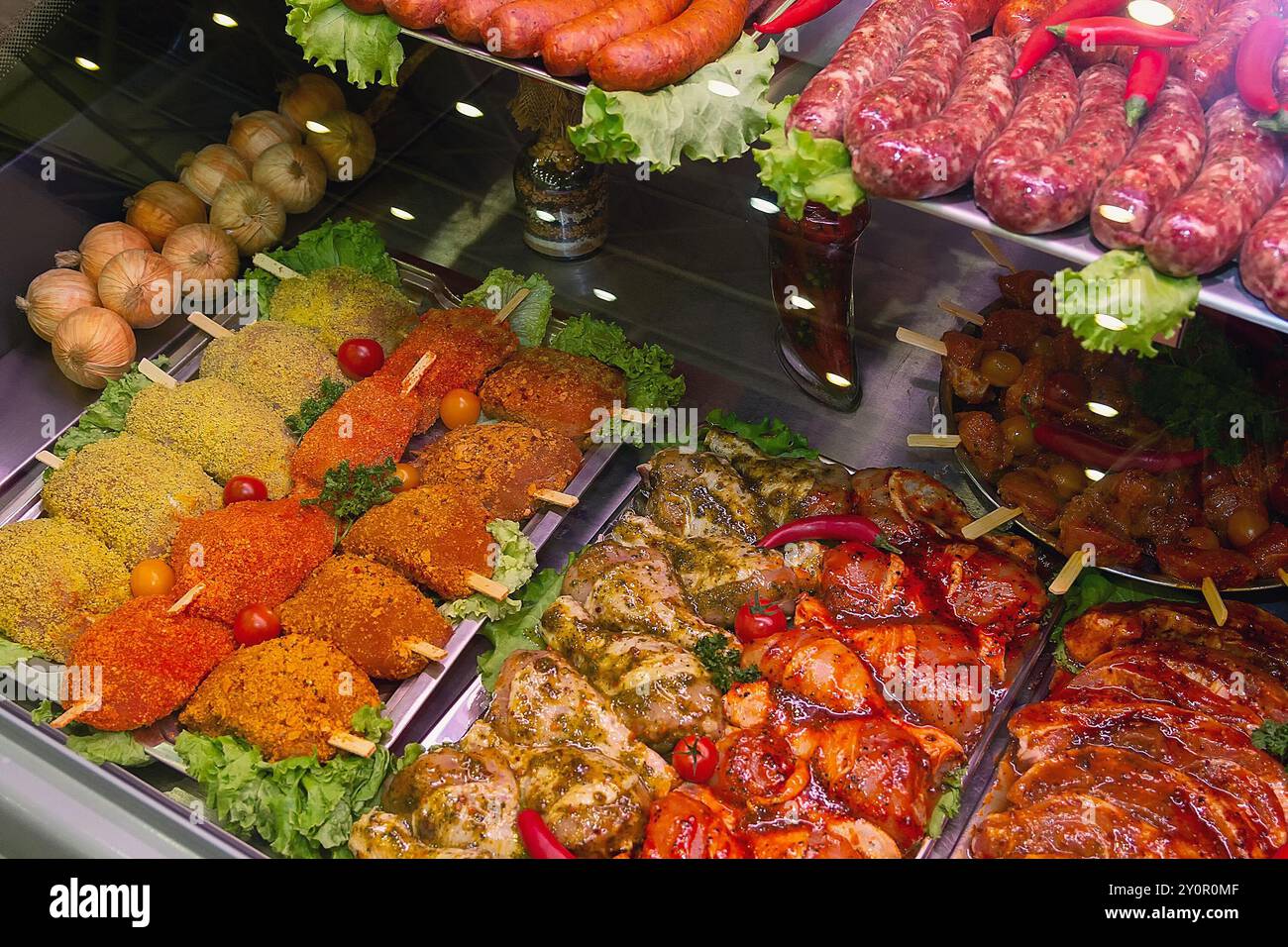 Various types of meat on the counter in a butcher shop. Preparations ...