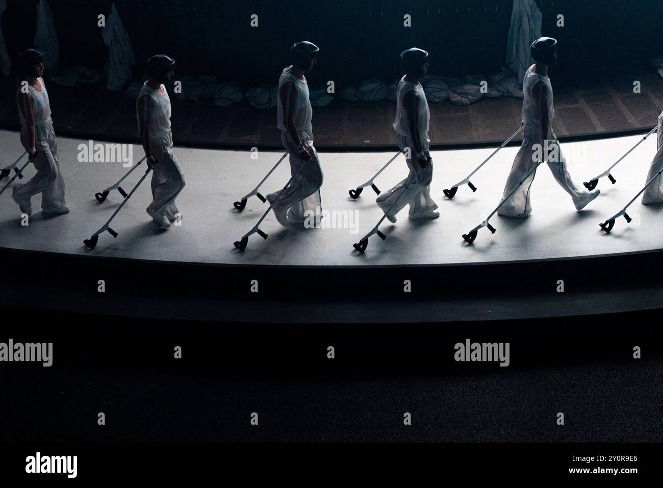 Performers and dancers walk with upturned Canadian batons on the main ...