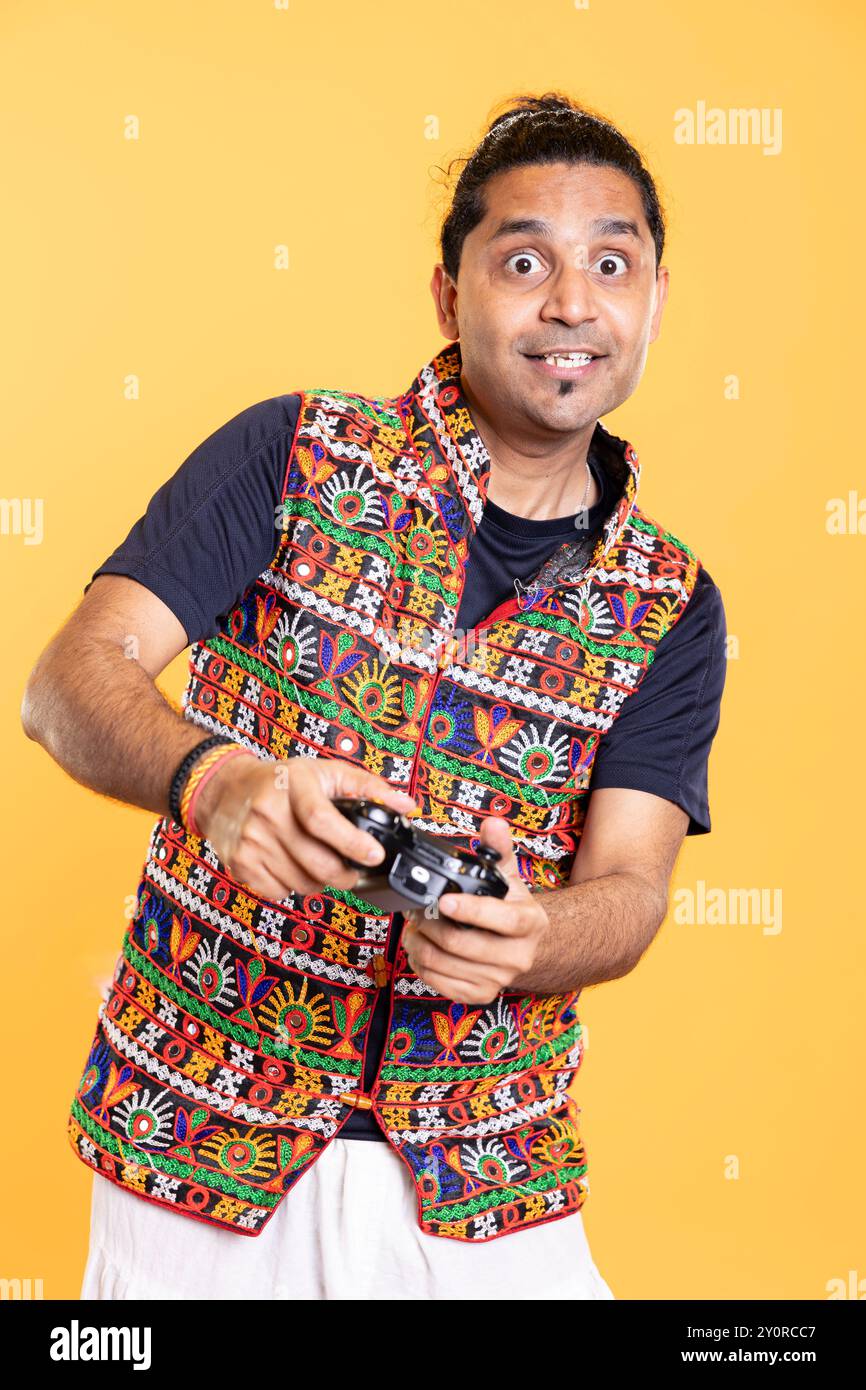 Portrait of joyous man being entertained by videogames, using ...