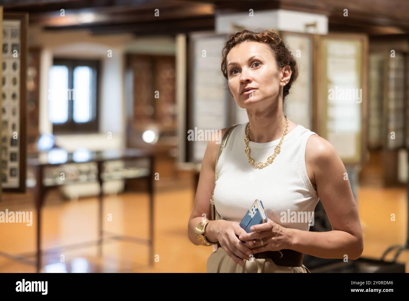 Historical museum - woman with smartphone in her hands looks at an ...