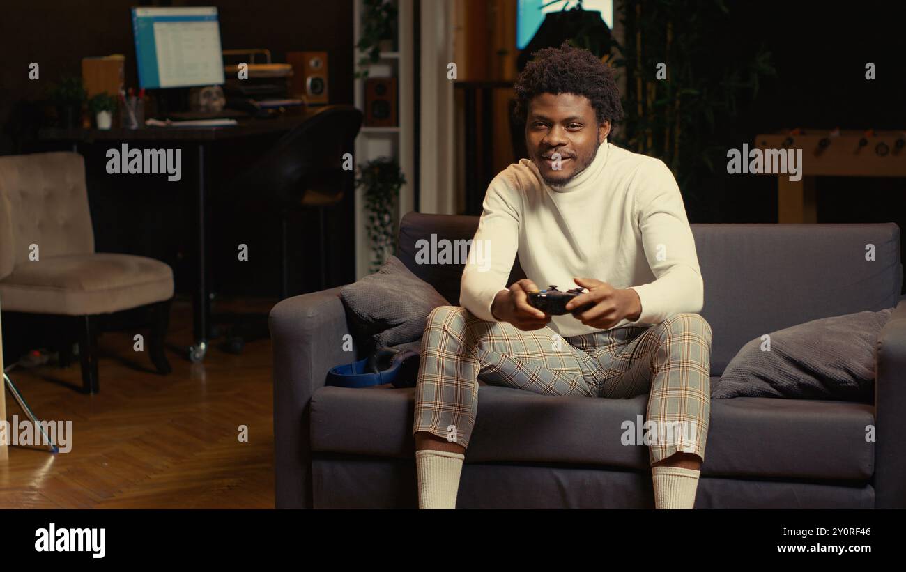 Cheerful gamer feeling excited after finally defeating all enemies and ...