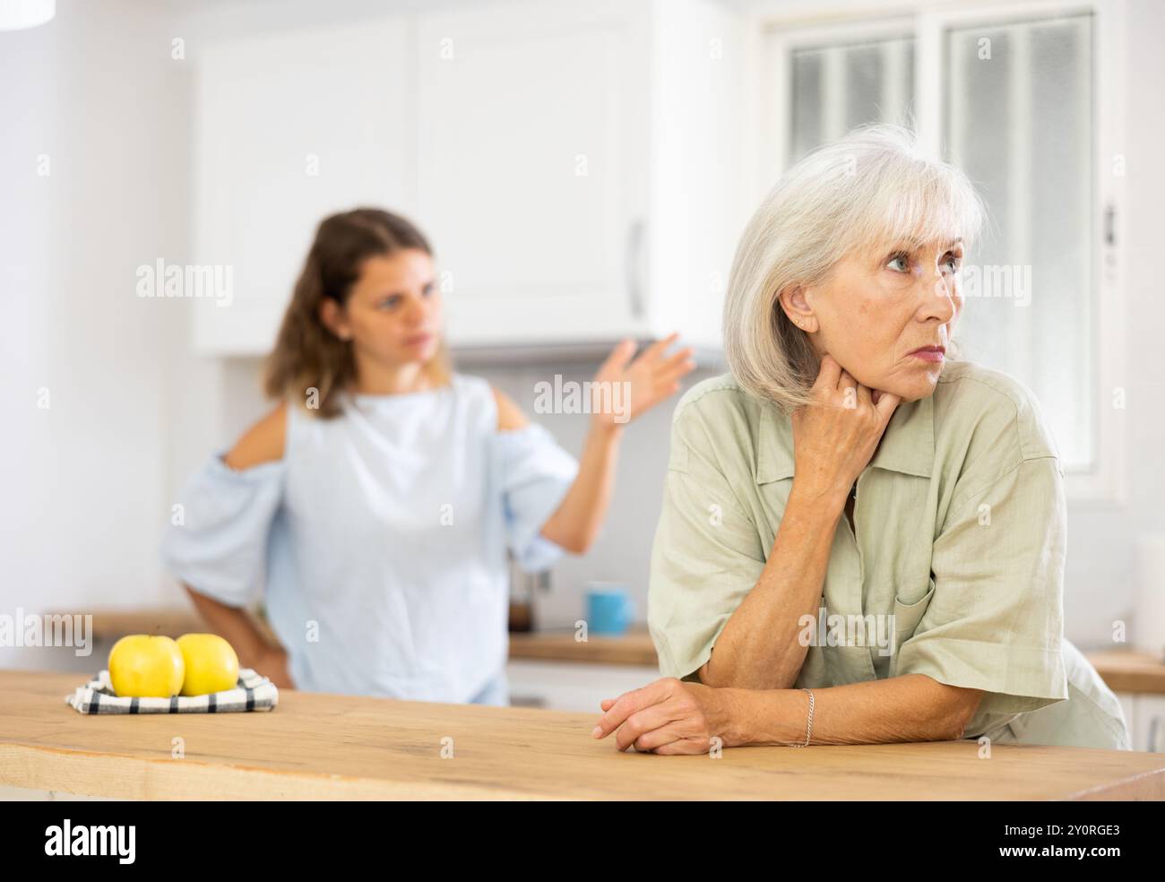 Sad senior woman ignoring her daughter arguing with her Stock Photo - Alamy