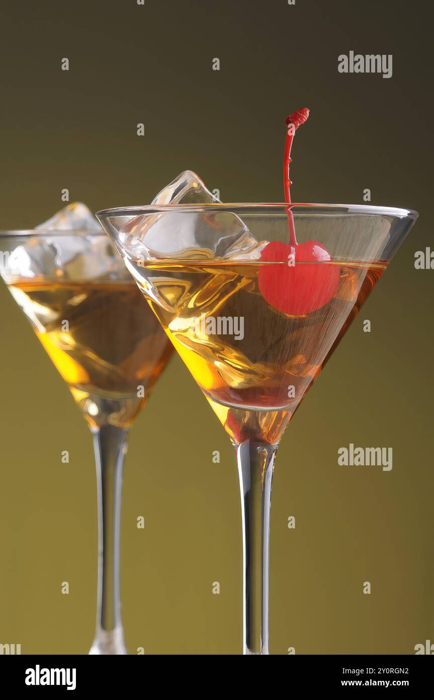 Two Manhattan Cocktails in Martini Glasses on warm background vertical ...