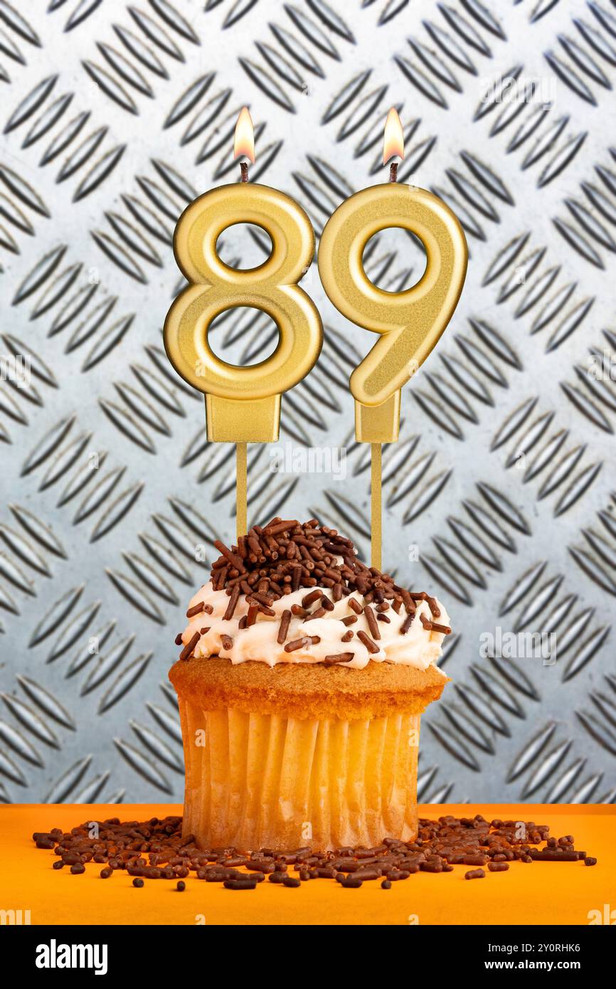 Chocolate cupcake with candle number 89 - Birthday on industrial ...