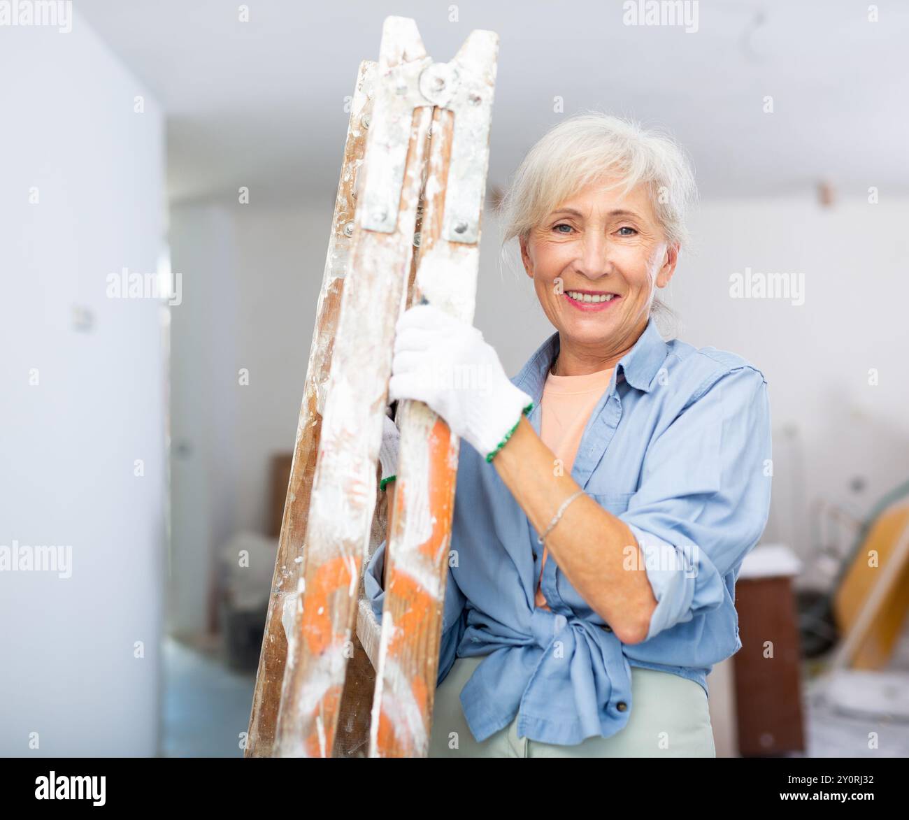 Mature woman carrying ladder, diy home renovation Stock Photo - Alamy